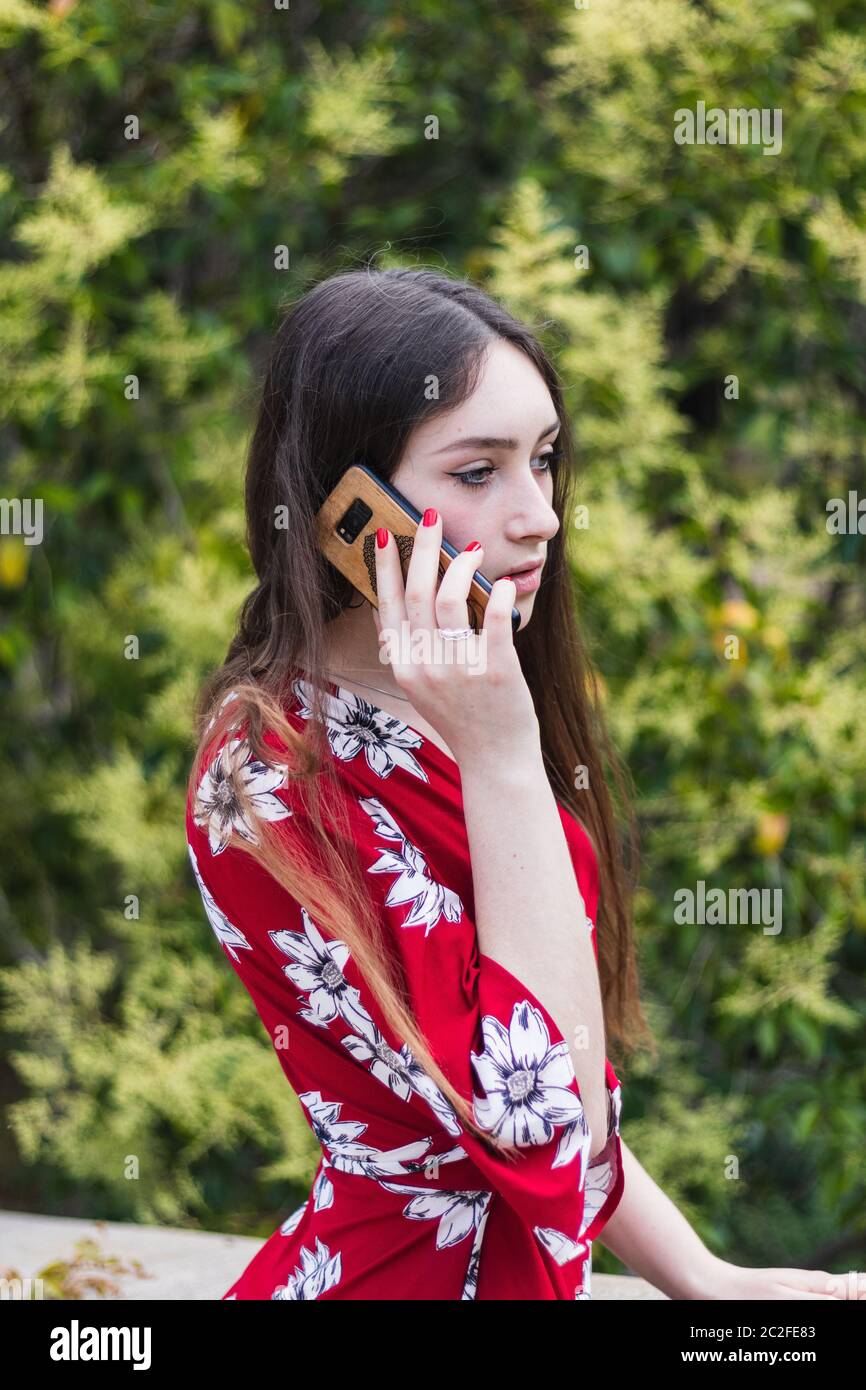 Attractive young woman making a call Stock Photo - Alamy