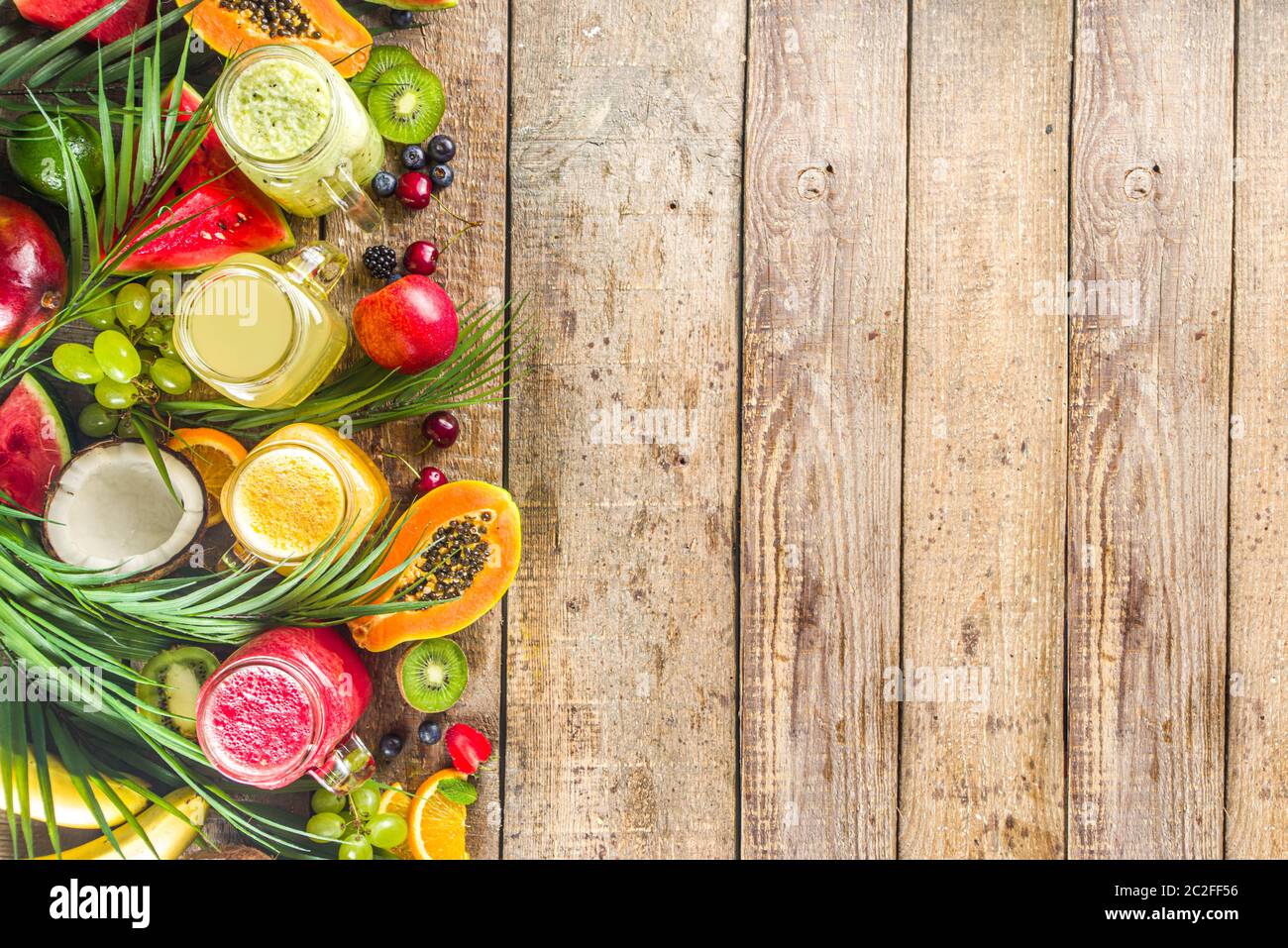 Assorted different fruit smoothies and juices with tropical fresh ...