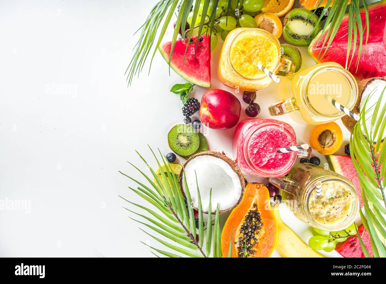 Assorted different fruit smoothies and juices with tropical fresh ...