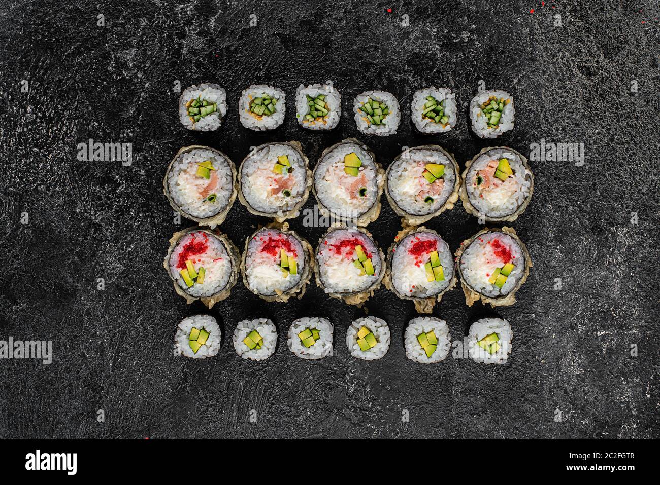 Traditional Japanese food - sushi, rolls and sauce on grey metal ...
