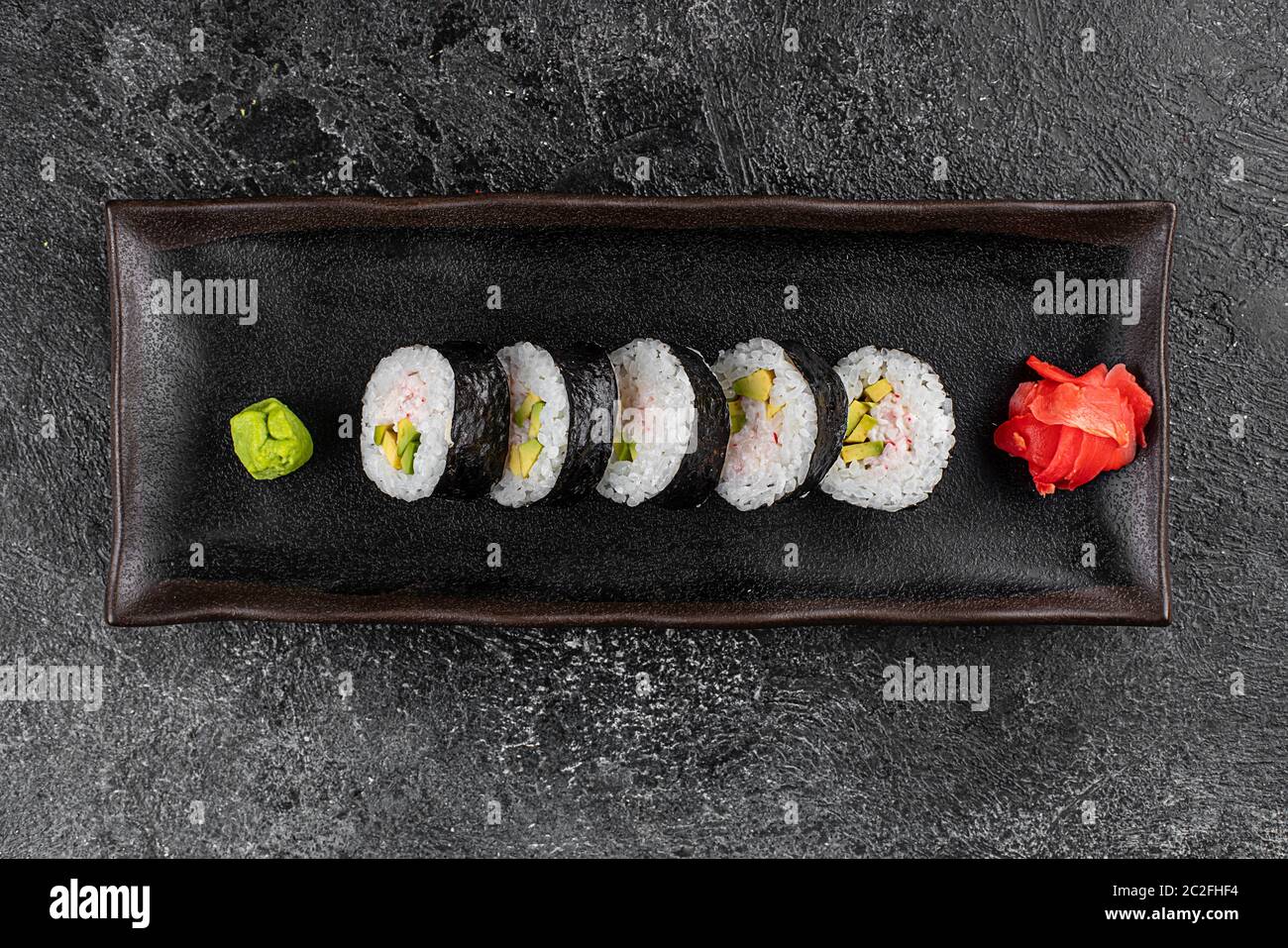 Sushi California Roll with crab meat, cucumber, masago, chopsticks on a ...