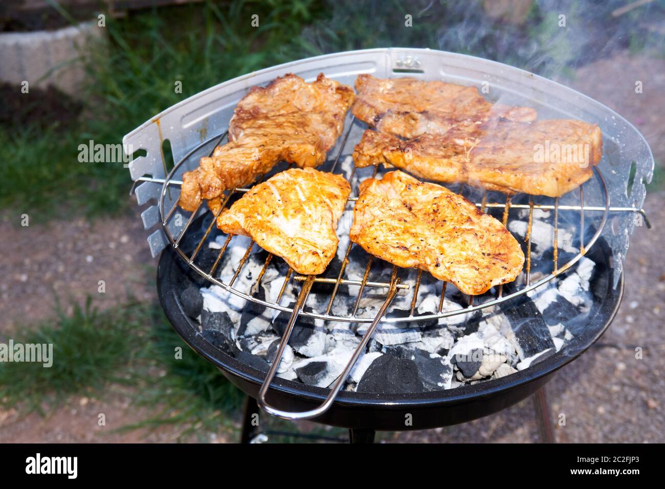 Barbecue grill with fire on nature, outdoor, close up Stock Photo - Alamy
