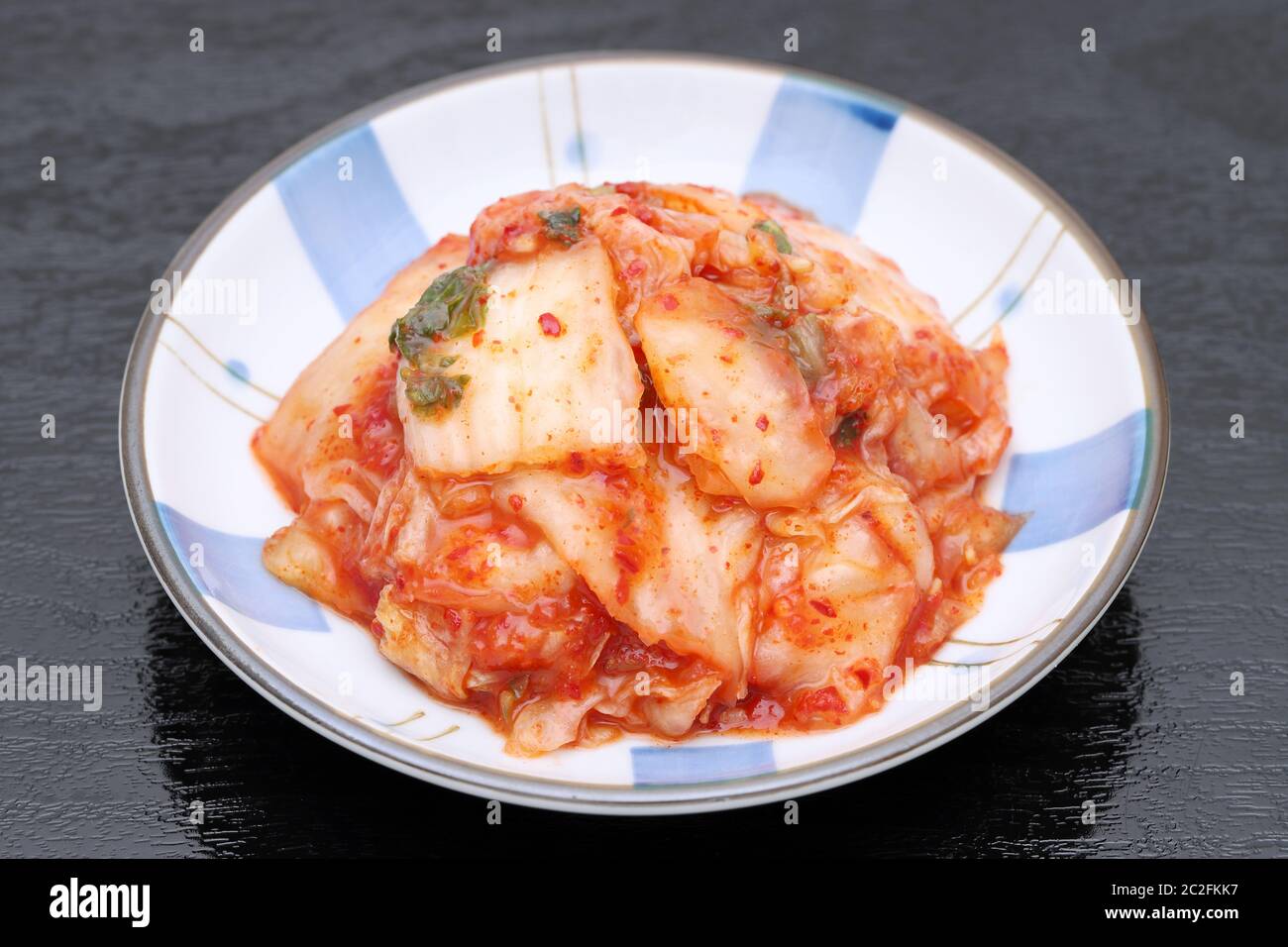 Kimchi (Korean food) close up on black background Stock Photo - Alamy
