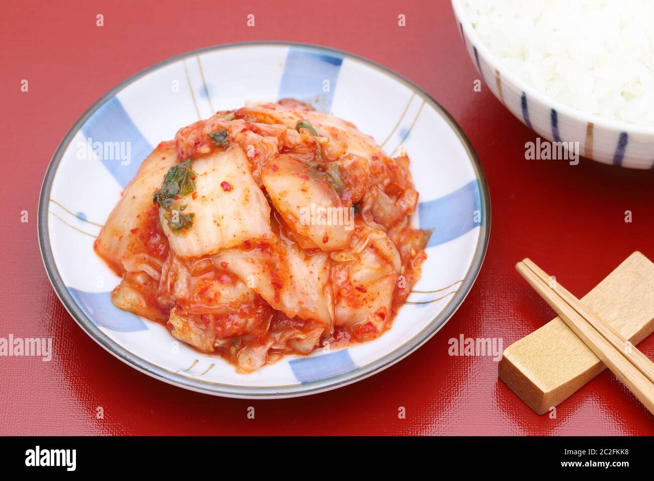 Kimchi (Korean food) close up on red background Stock Photo - Alamy