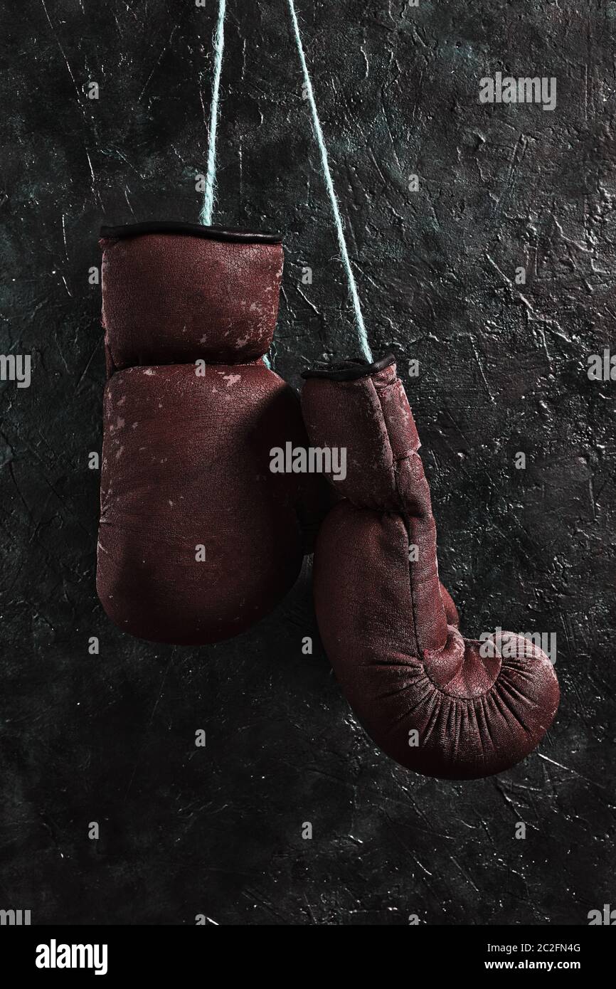 Old red Boxing gloves hanging on the wall Stock Photo - Alamy