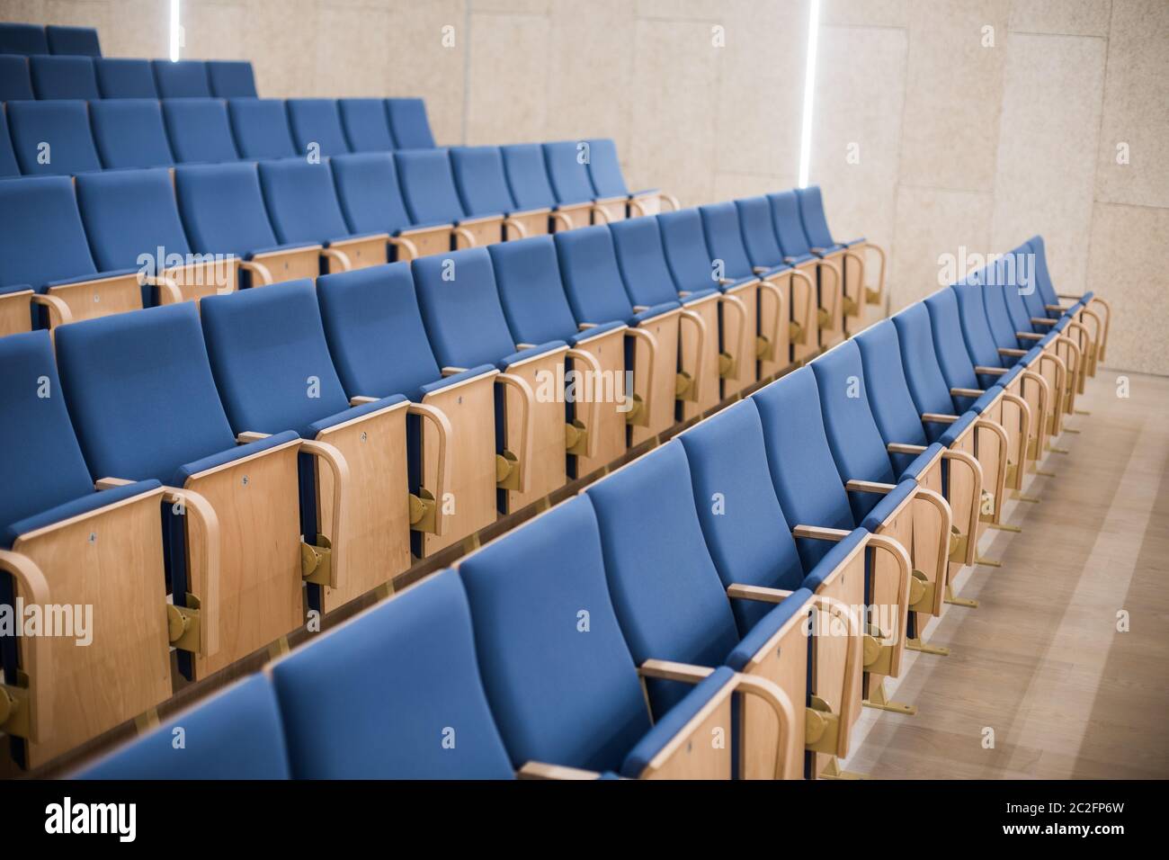 Image of rows of empty blue seats in a conference room Stock Photo - Alamy