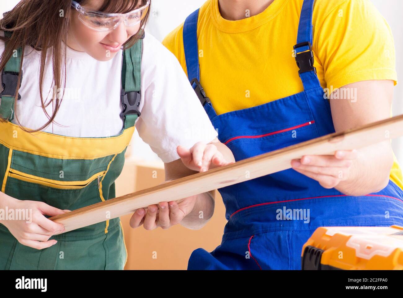 Woman laying wood flooring hi-res stock photography and images - Alamy