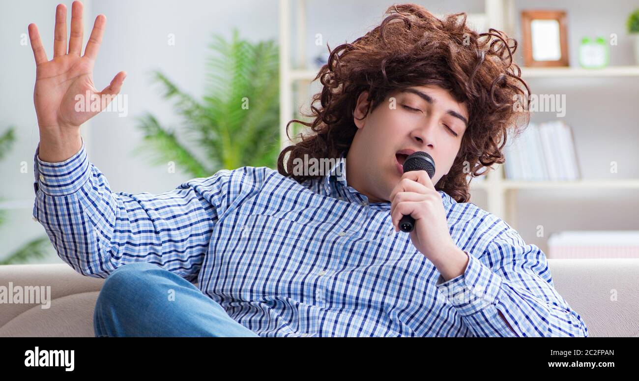 Funny man singing songs in karaoke at home Stock Photo - Alamy