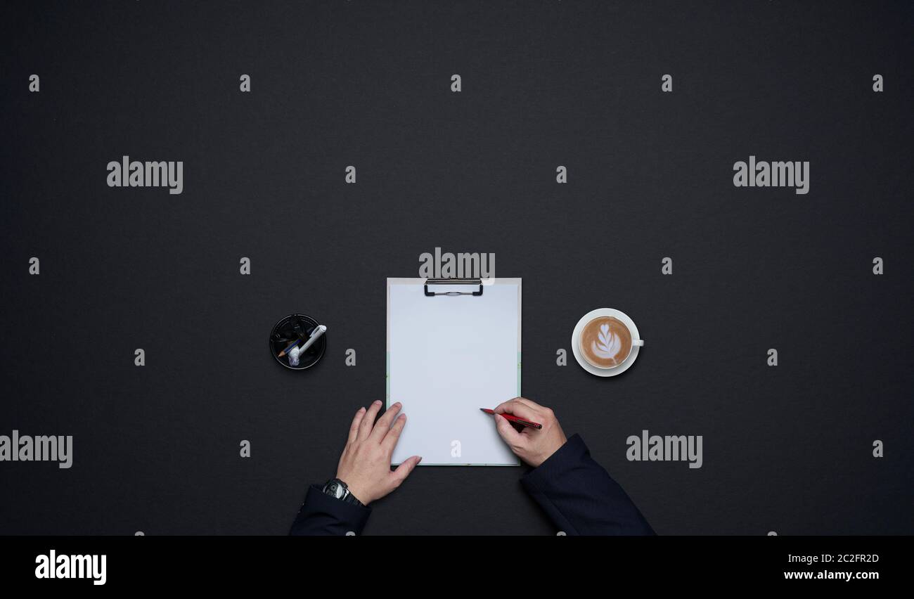 Businessman hands writing on white paper . Flat lay and top view with ...