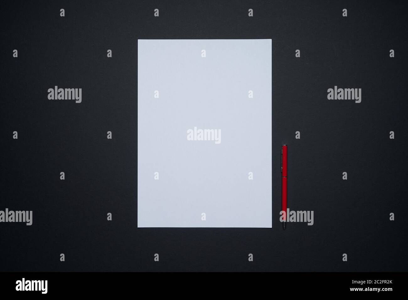 White sheet paper and red pen isolated on black background Stock Photo ...