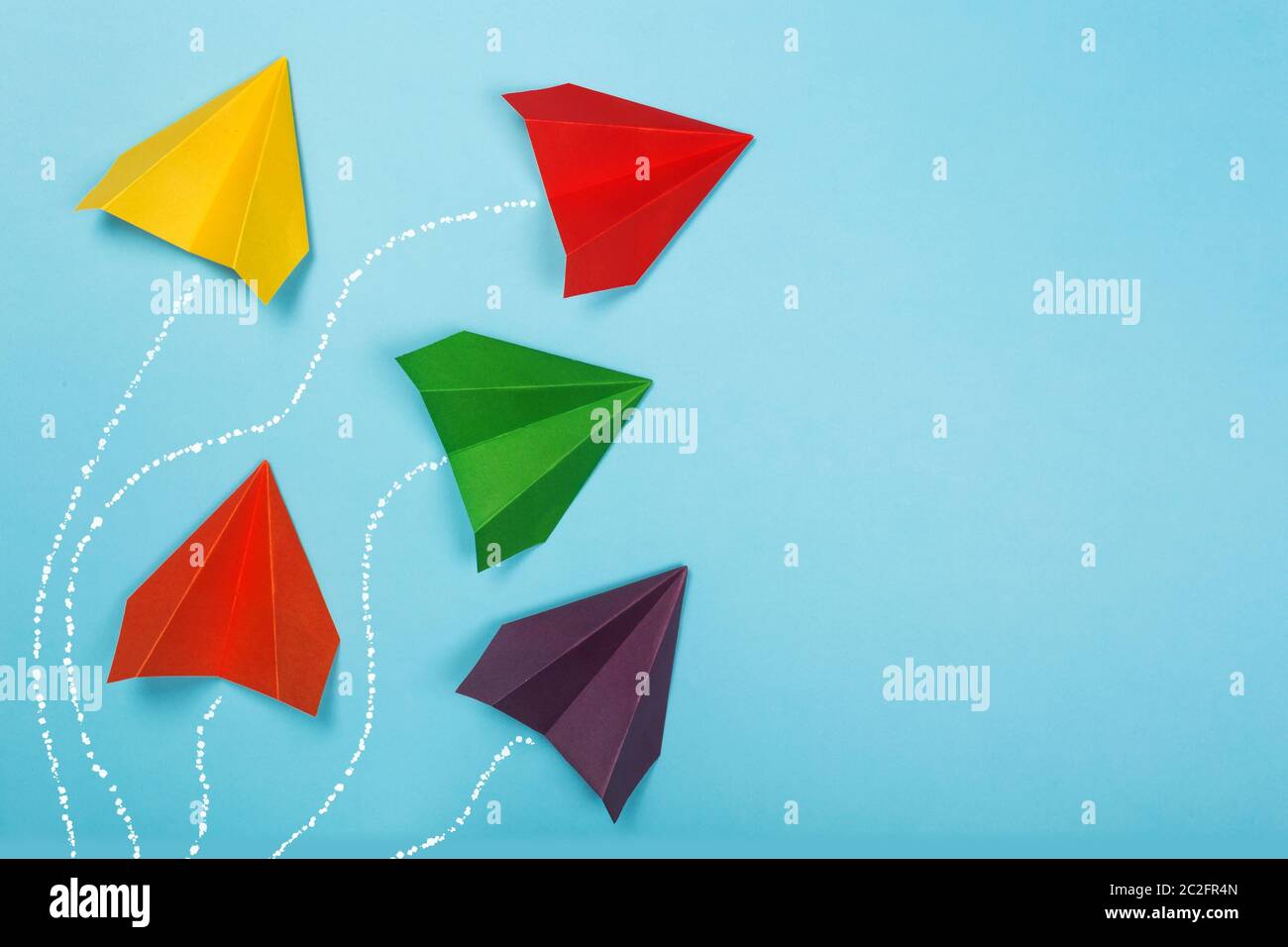Color paper airplanes on blue background. top view Stock Photo - Alamy