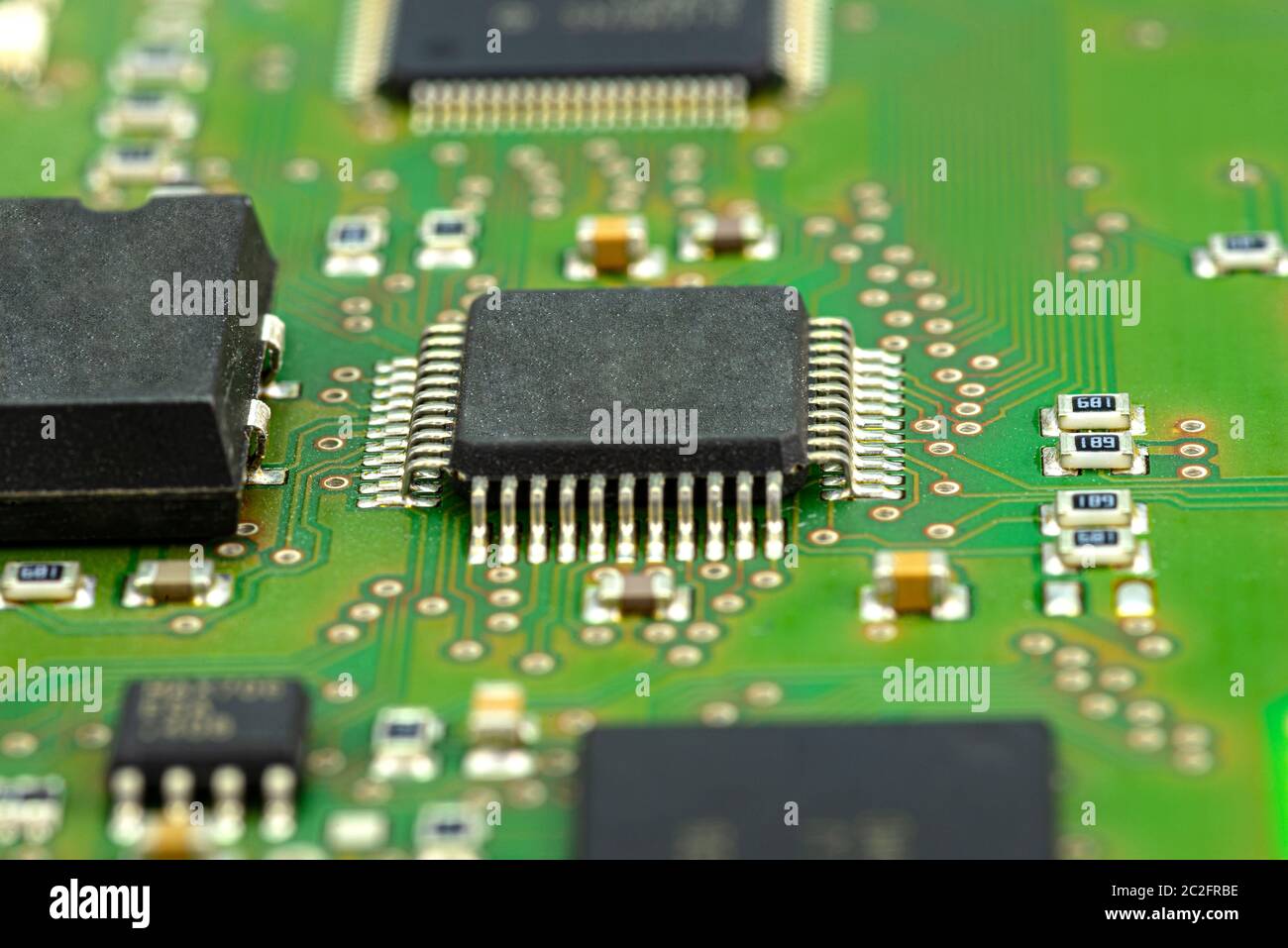 Macro photo of integrated circuit on a green circuit board, visible ...