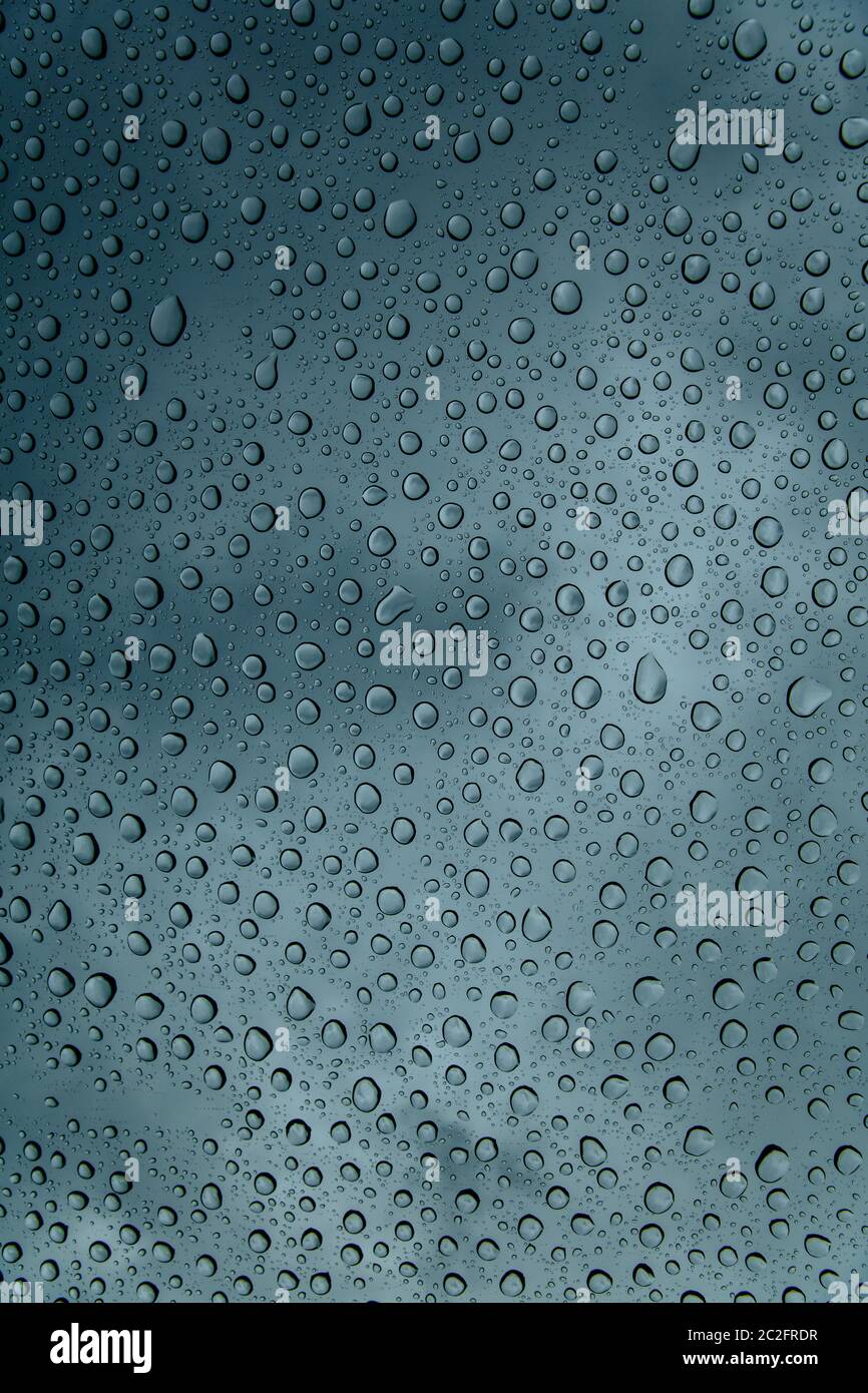 Natural background of rain splash drops on window glass with reflection ...