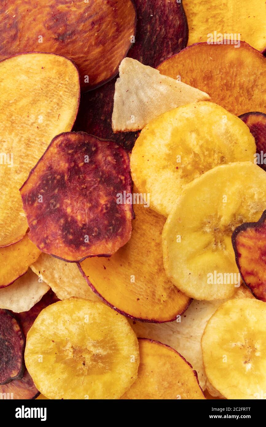 A close-up of dry fruit and vegetable chips, healthy vegan snack, a ...