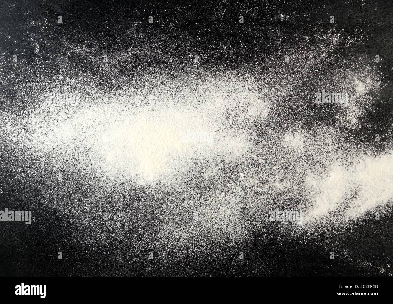 sprinkled white flour on the black table, top view, full frame Stock ...