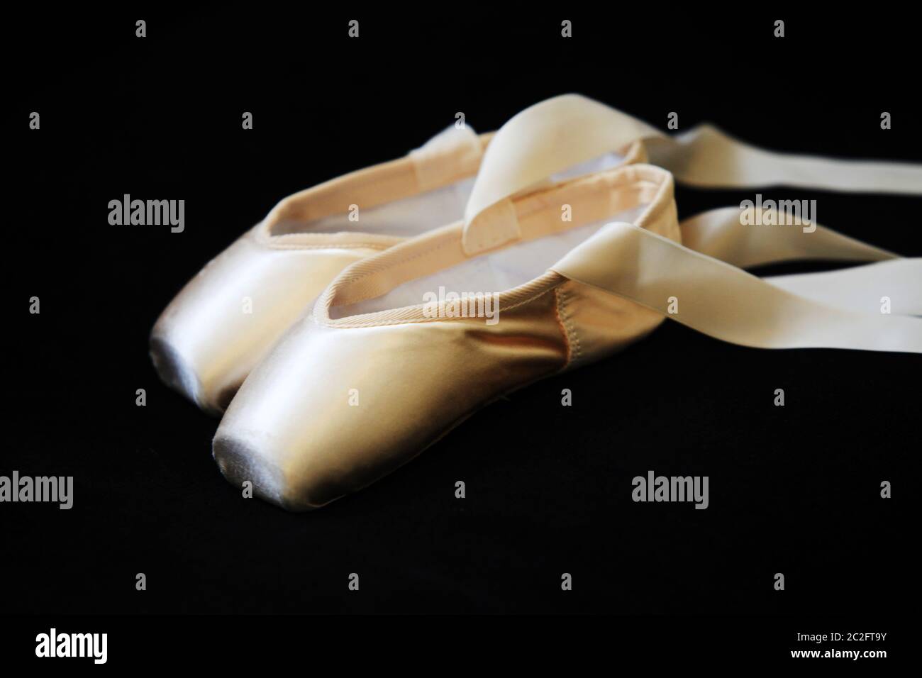 Ballet pointes isolated on a black background Stock Photo - Alamy