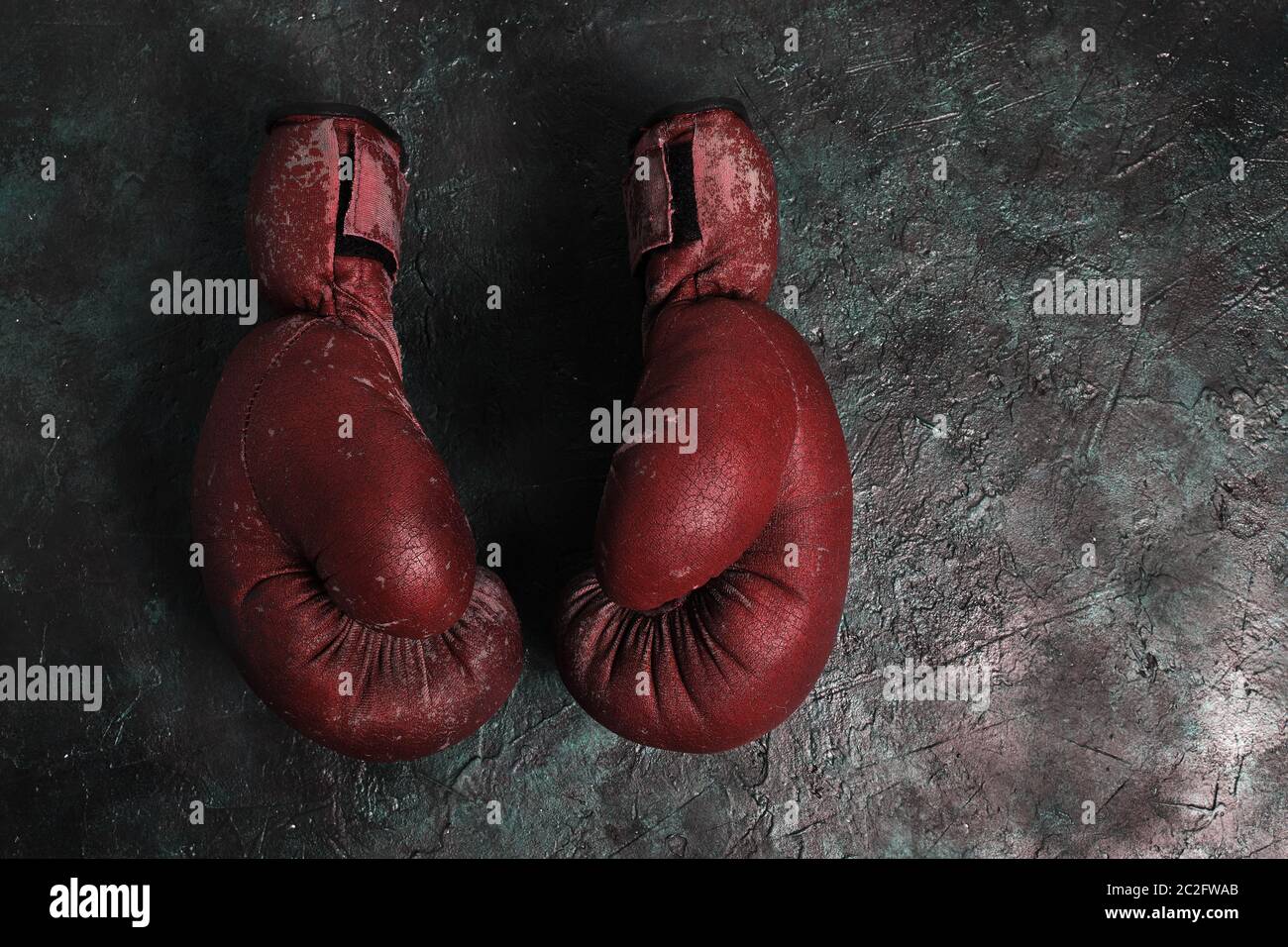 Old red Boxing gloves on a concrete background Stock Photo - Alamy