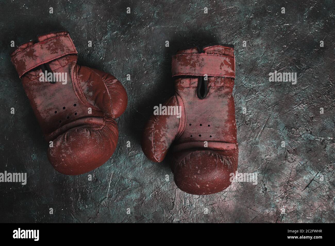 Old red Boxing gloves on a concrete background Stock Photo - Alamy