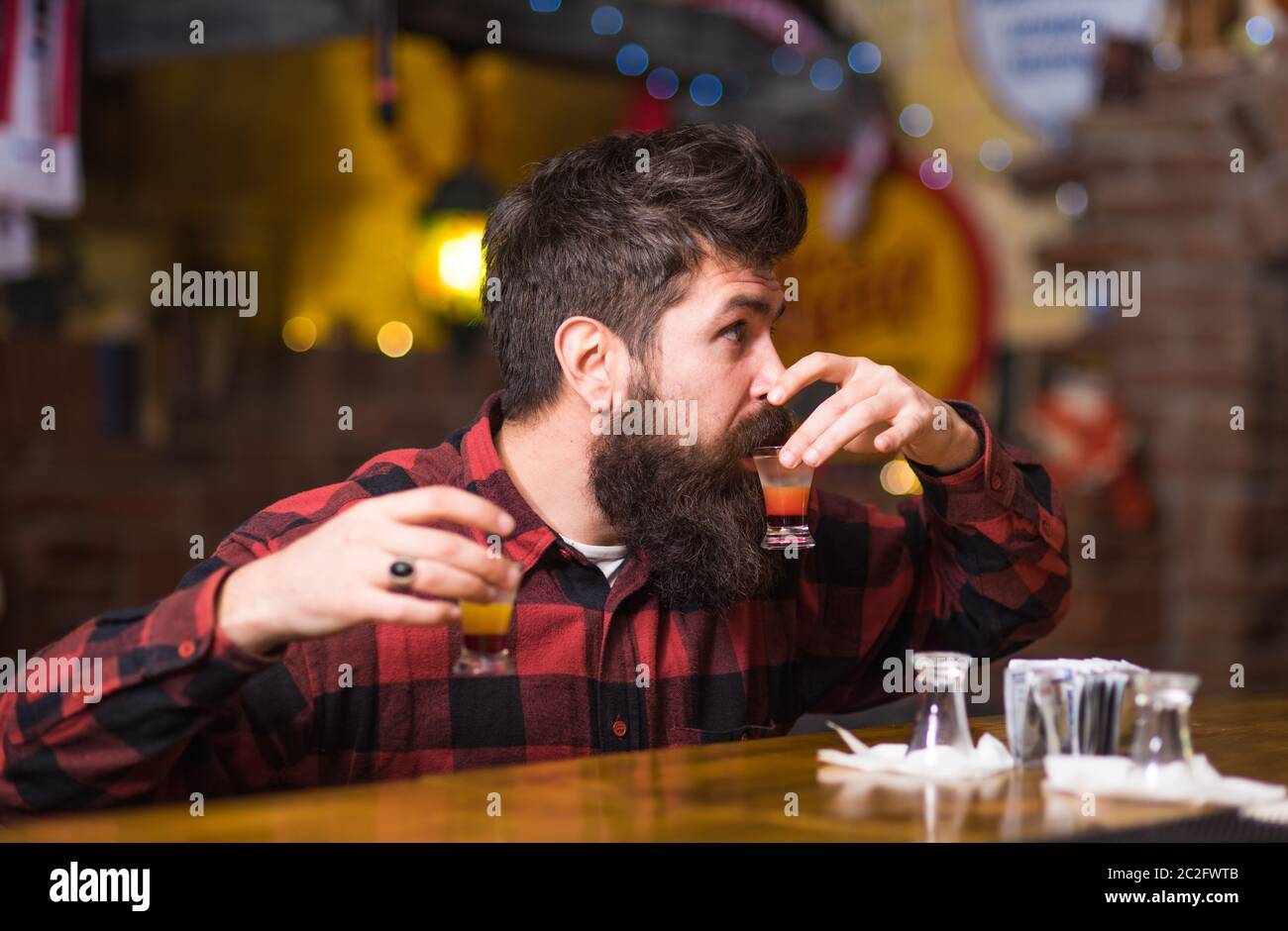 Get drunk concept. Hipster holds glass with alcoholic drink, short ...
