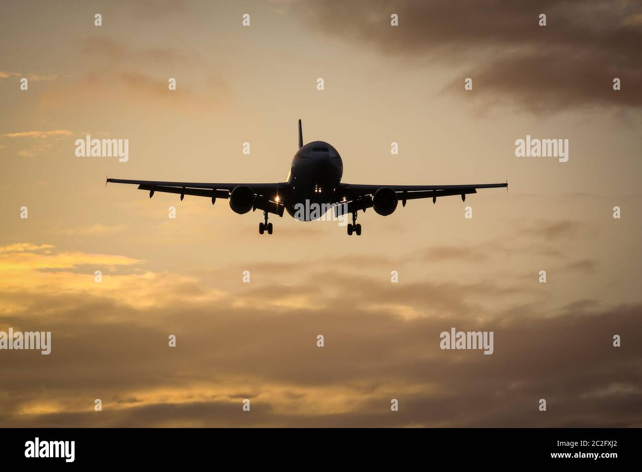 air plane in sunset sky Stock Photo - Alamy