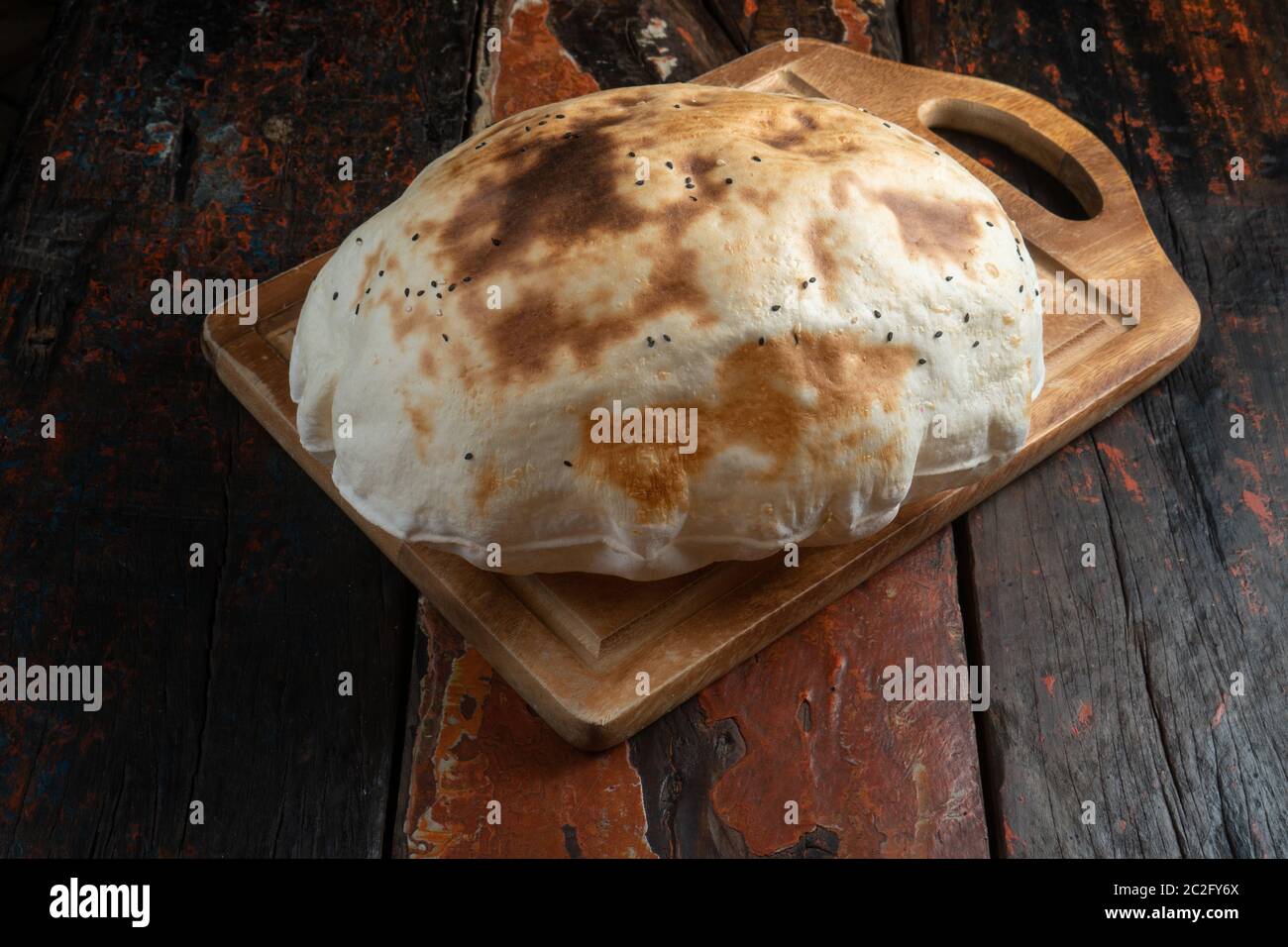 Traditional Turkish bread isolated on rustic wooden table Stock Photo ...