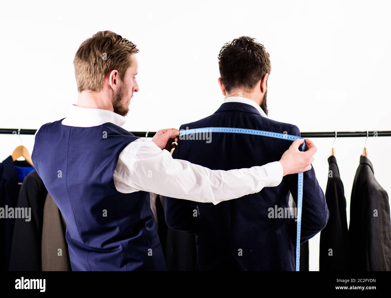 Tailor measure back for sewing suit, white background. Taking ...