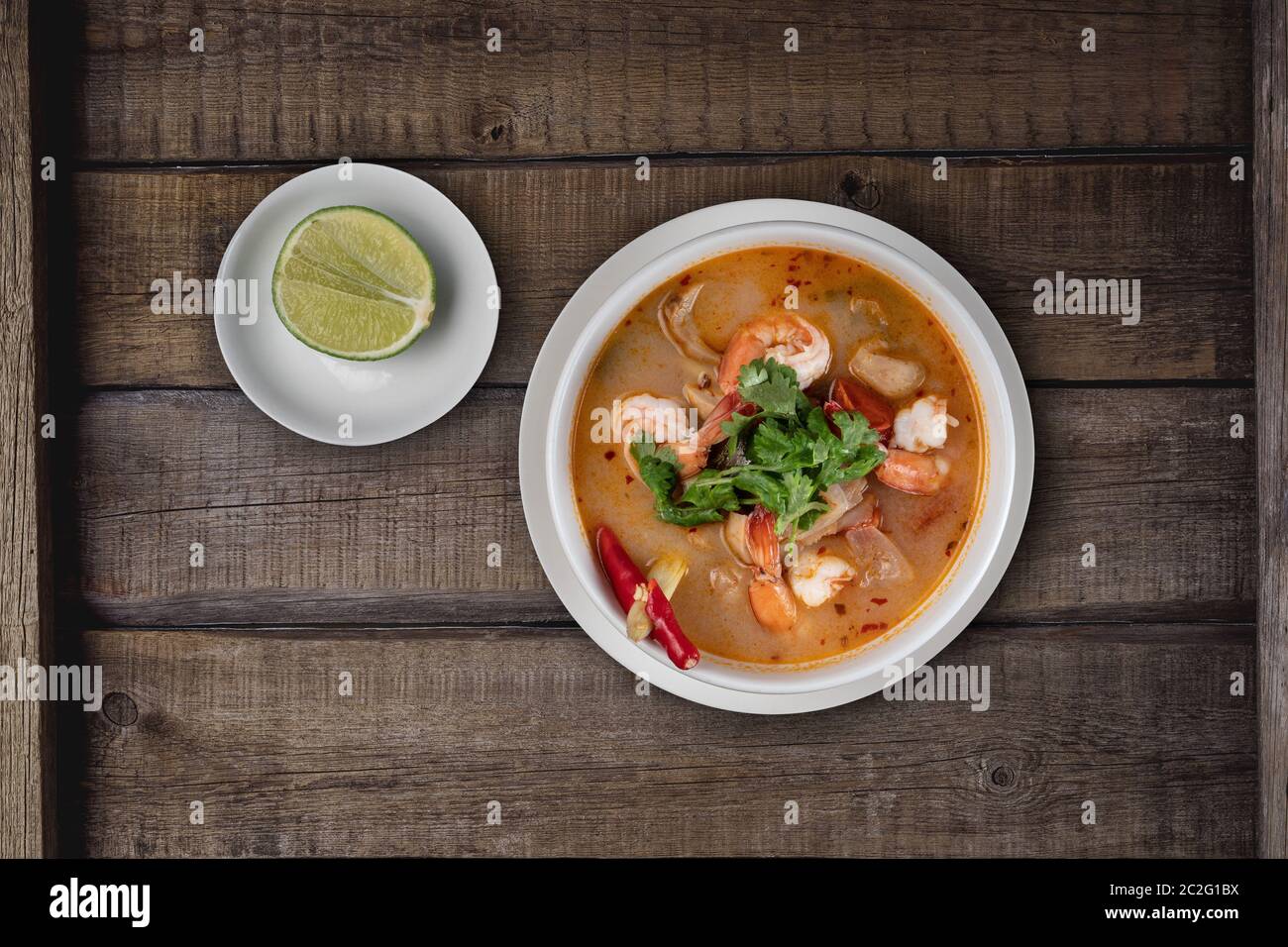 Top view Thai food Tom Yum soup with shrimps isolated on rustic wooden table Stock Photo - Alamy