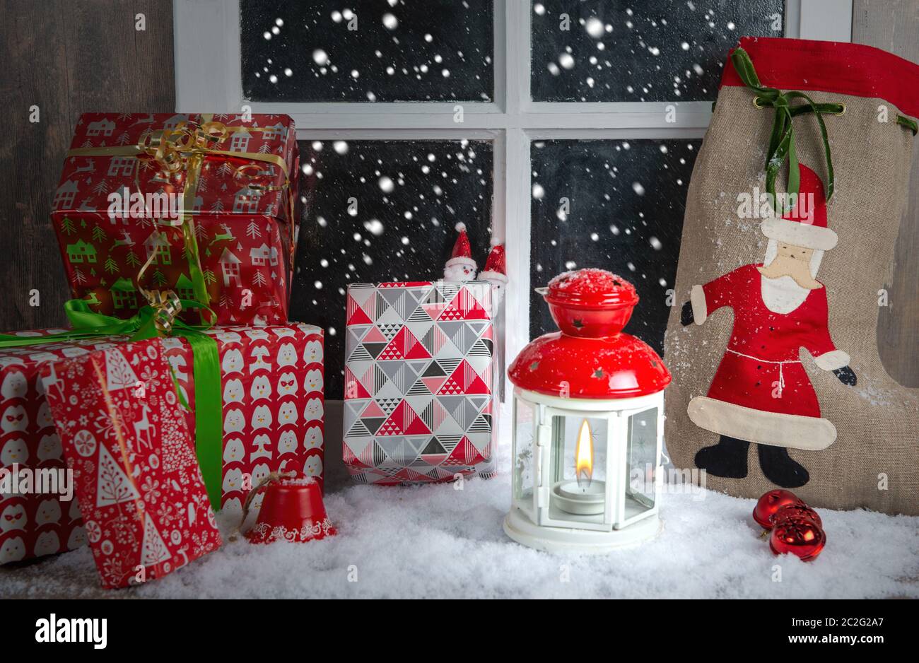 the Christmas gifs decoration near the rustic window Stock Photo - Alamy