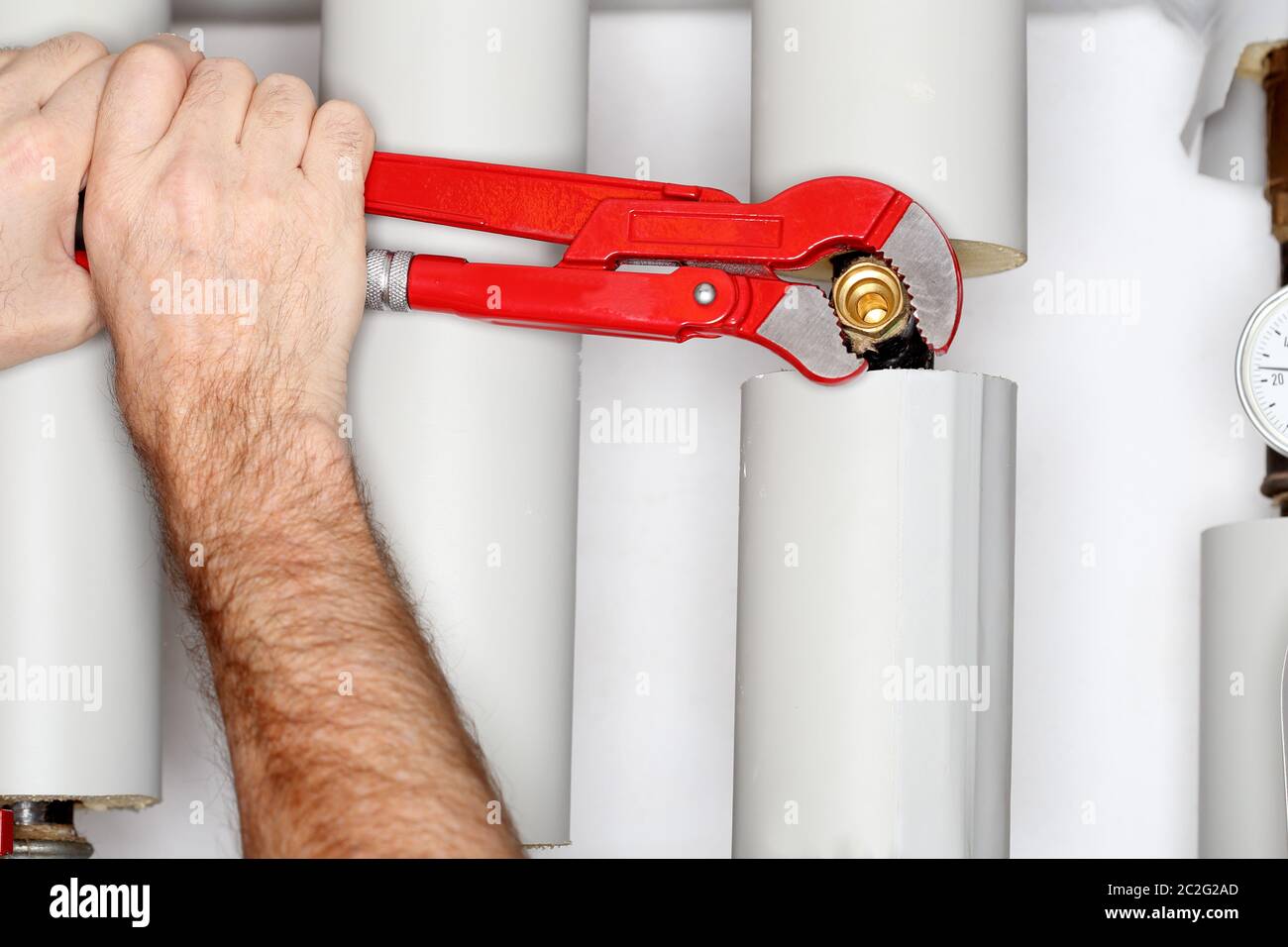 repair man is fixing a problem in a heating room Stock Photo - Alamy