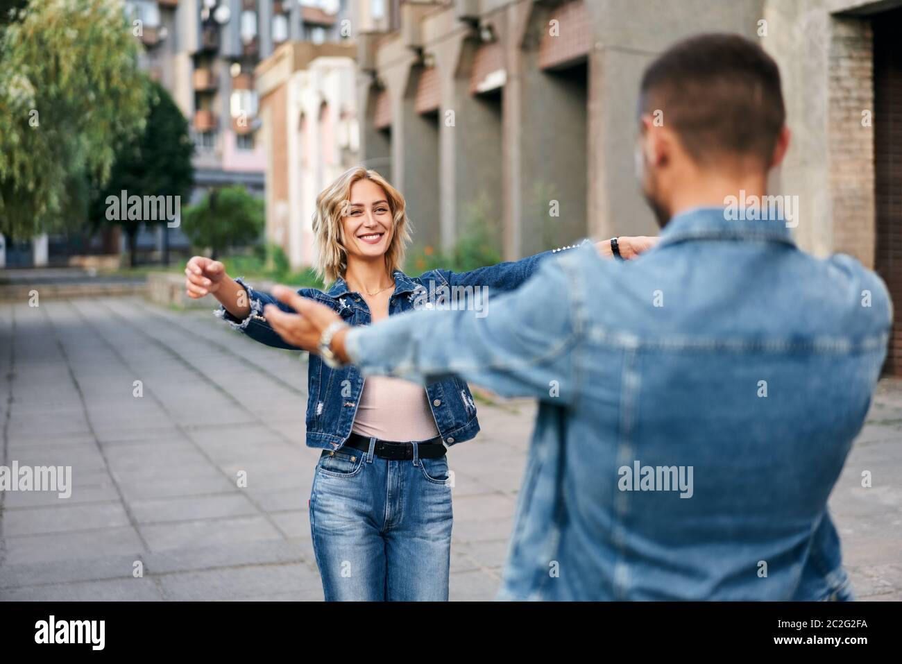 Happy meeting two friends hugging hi-res stock photography and images ...