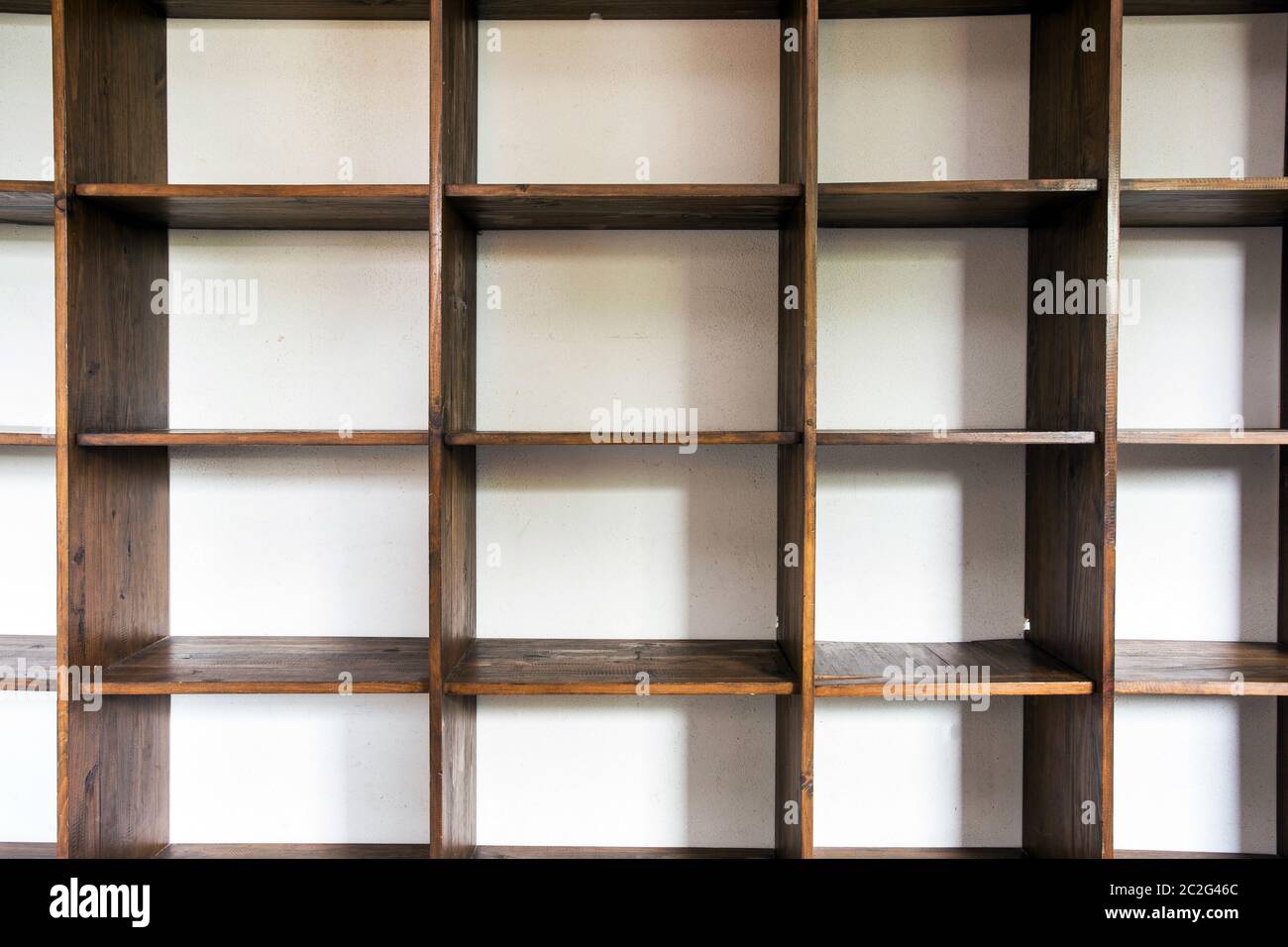 empty wooden cupboard storage near white wall, modern interior closeup ...