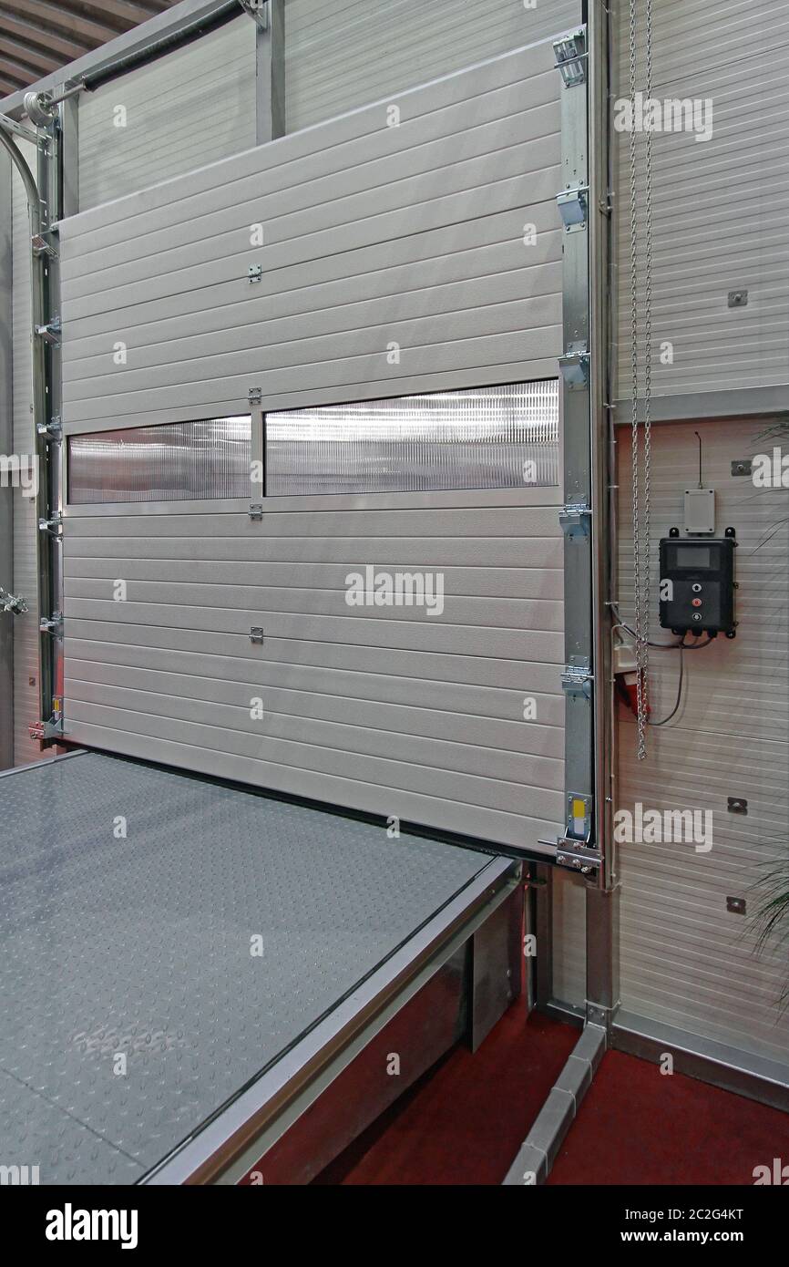 Industrial Roll Loading Cargo Door in Warehouse Stock Photo - Alamy