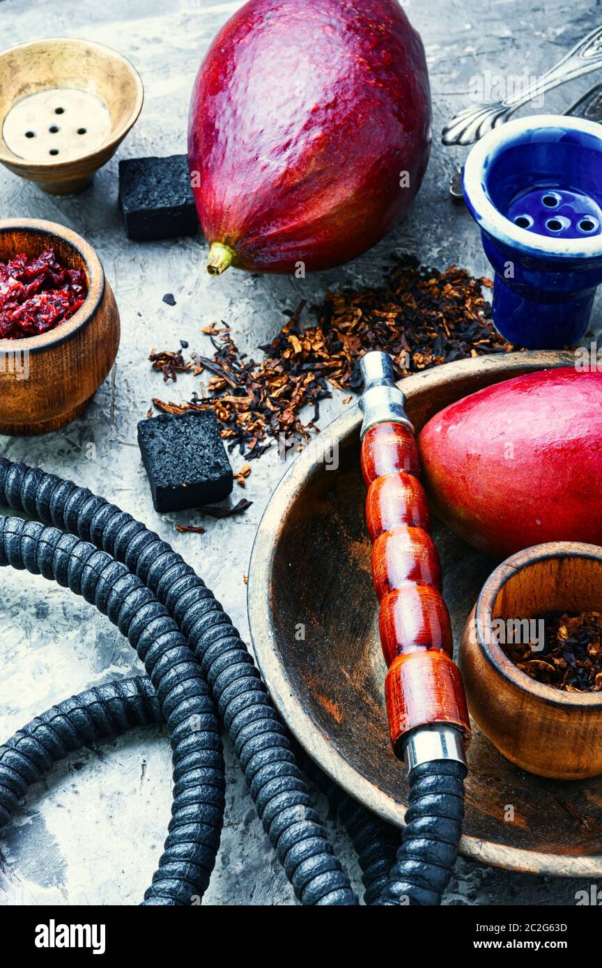 Smoking hookah.Details of shisha.Shisha with mango aroma of tobacco ...