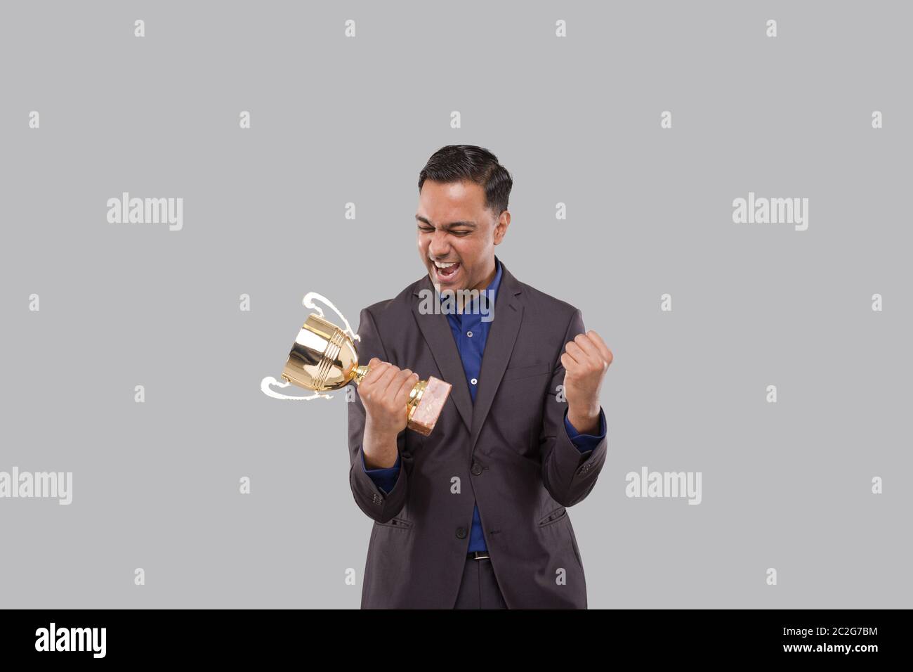 Winner celebrating holding trophy hi-res stock photography and images ...