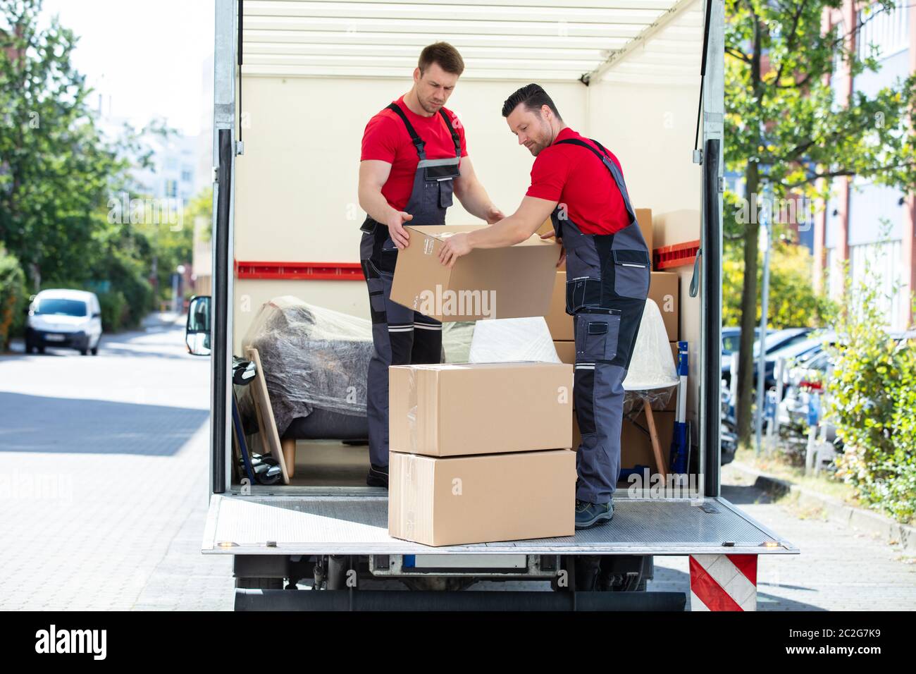 Two men unloading boxes hi-res stock photography and images - Alamy