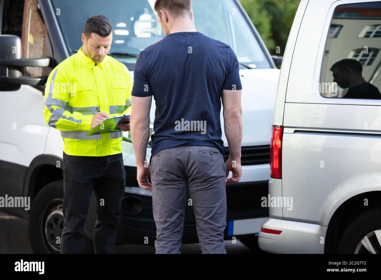 Close-up Of A Male Insurance Agent Wearing Safety Jacket Filing Report ...