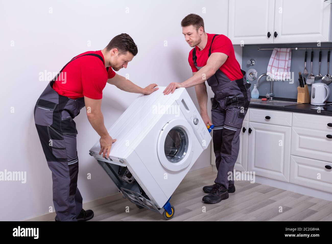 Man carrying washing machine hi-res stock photography and images - Alamy