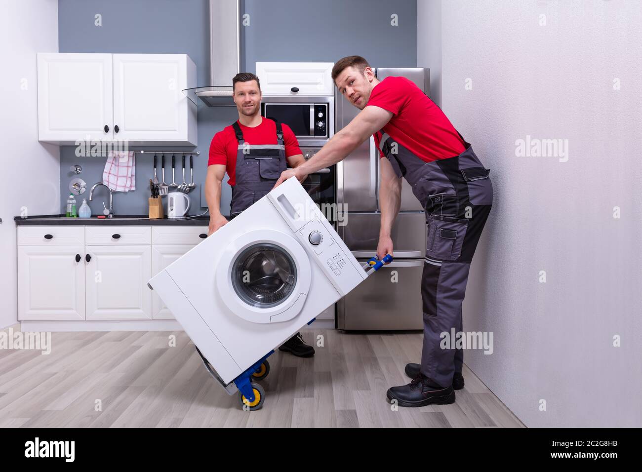 Man carrying washing machine hi-res stock photography and images - Alamy