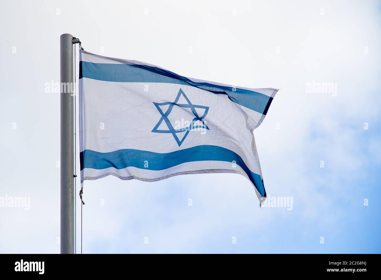 Israel flag is waving in front of blue sky Stock Photo - Alamy