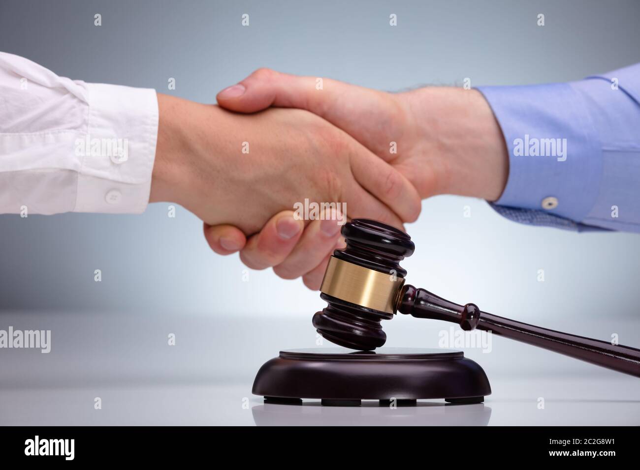 Mallet And Sound Block In Front Of Attorney Shaking Hand To Client ...