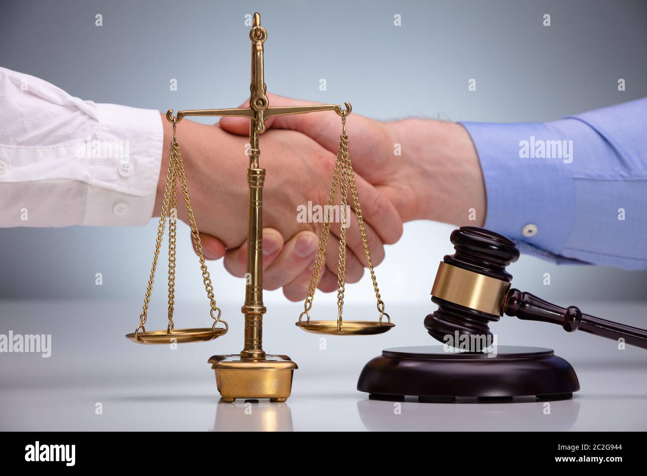 Mallet And Sound Block In Front Of Attorney Shaking Hand To Client ...