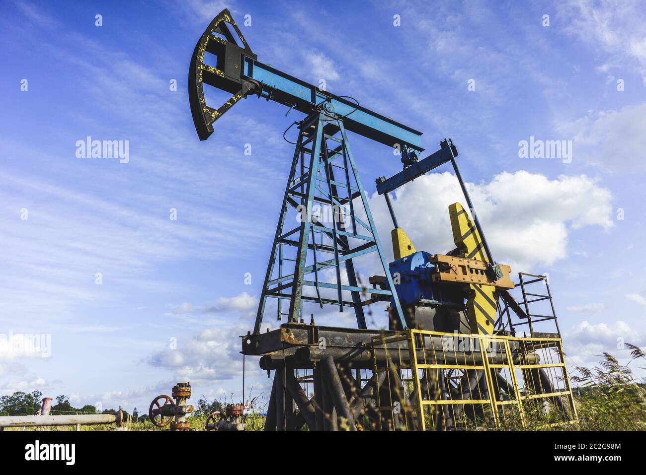 Production of Oil: Oil Rig on Blue Sky Background Stock Photo - Alamy