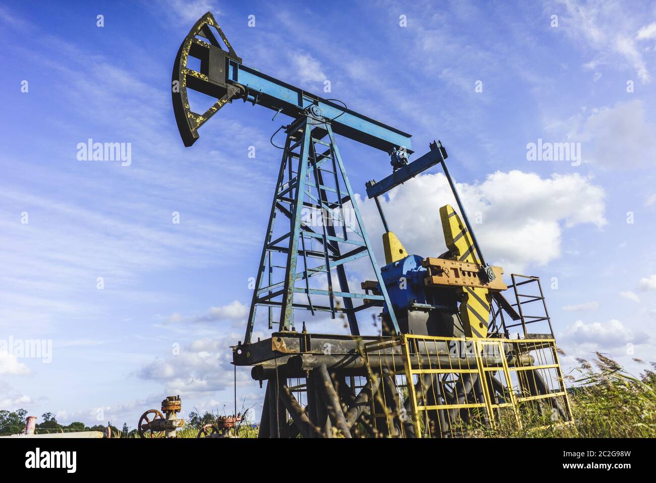 Production of Oil: Oil Rig on Blue Sky Background Stock Photo - Alamy