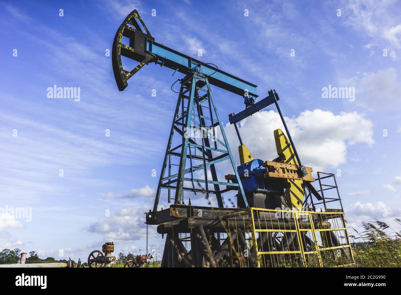 Production of Oil: Oil Rig on Blue Sky Background Stock Photo - Alamy