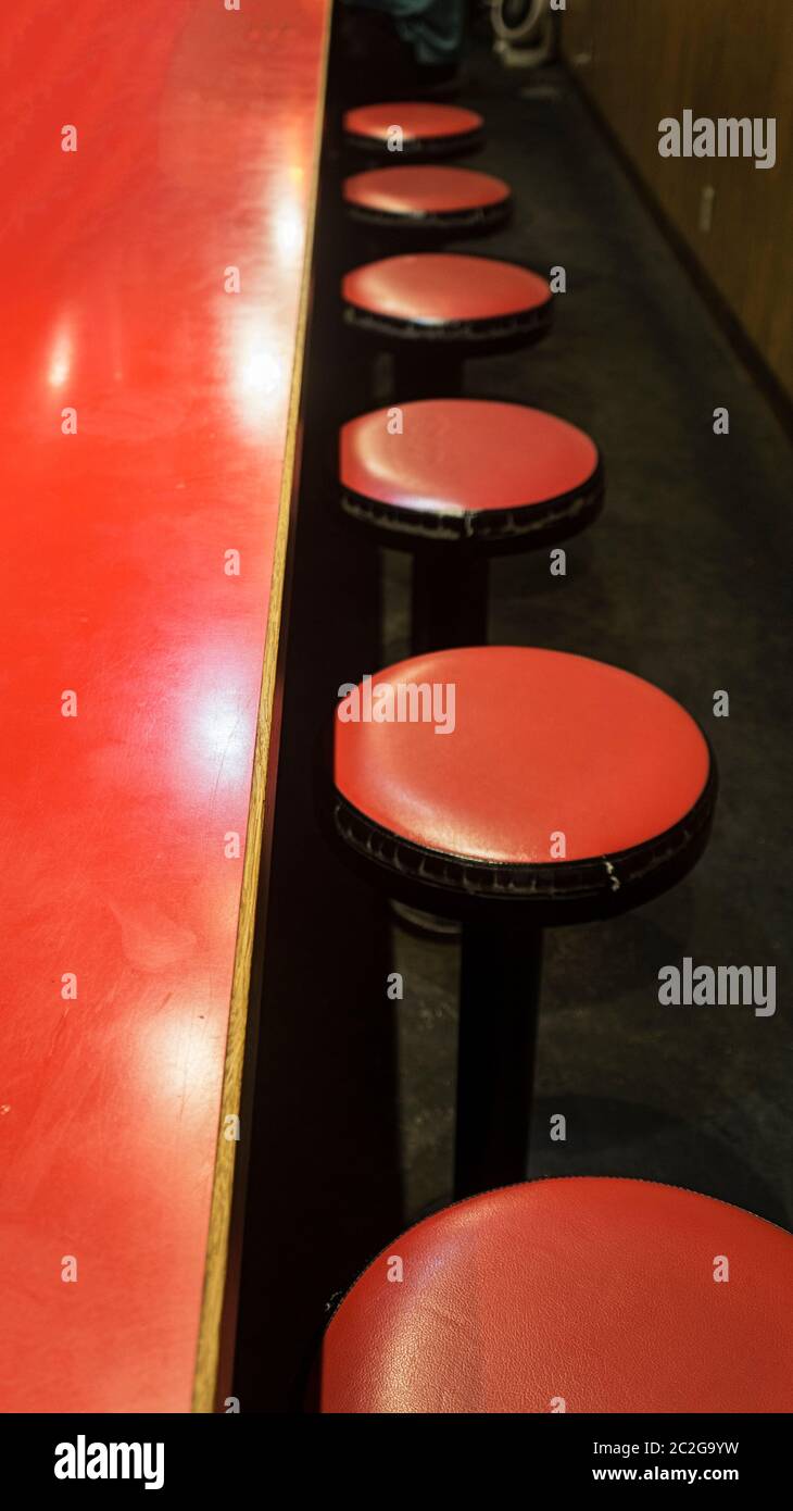 round seats red interior retro style pub classic Stock Photo - Alamy