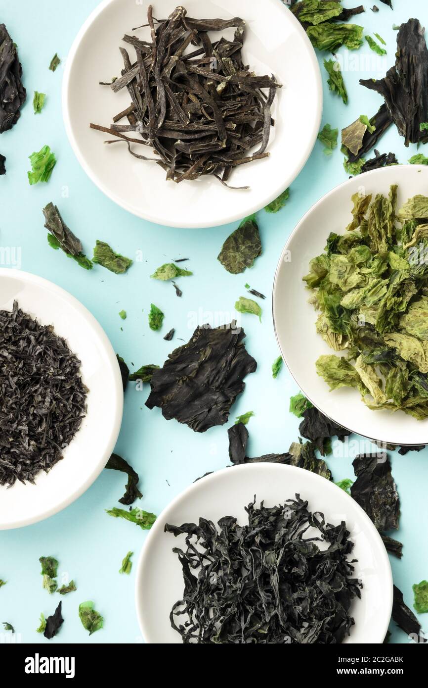 Dry seaweed, sea vegetables, overhead shot on a teal blue background ...