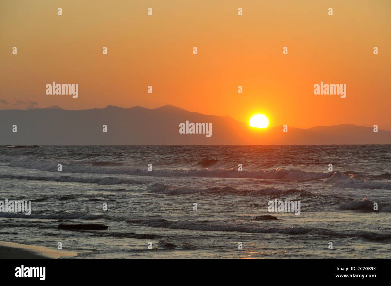 sunset on a beach on Crete Stock Photo - Alamy