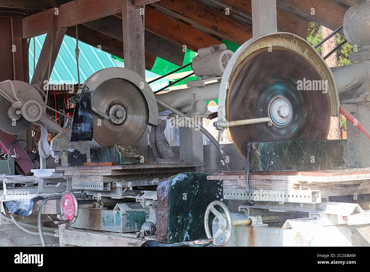 Large cutting blades cut through blocks of stone Stock Photo - Alamy