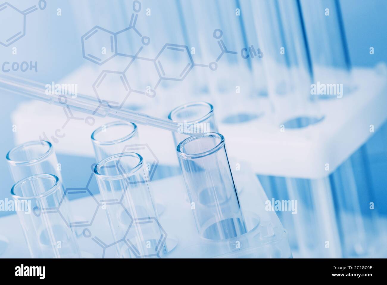 Laboratory glassware with a dropper dripping liquid into a test tube ...