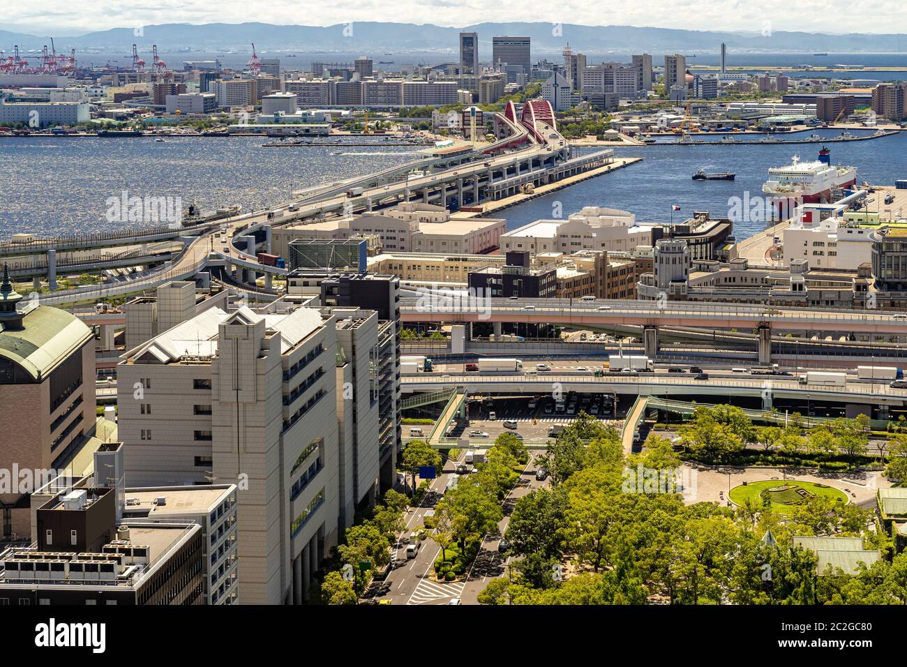 Aerial view of Kobe cityscape and red bridge at port area in Kobe ...